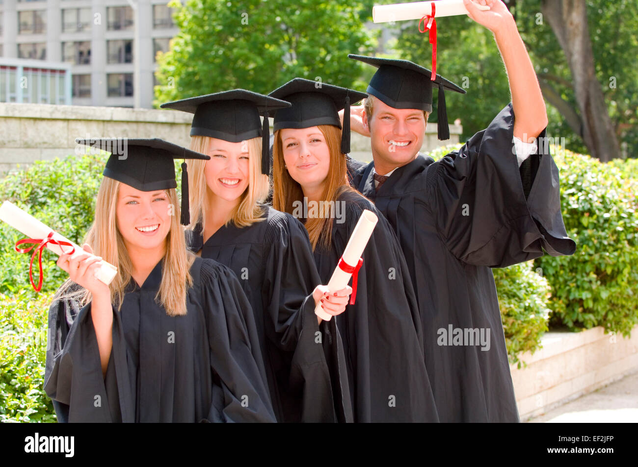 Four friends at graduation ceremony Stock Photo - Alamy