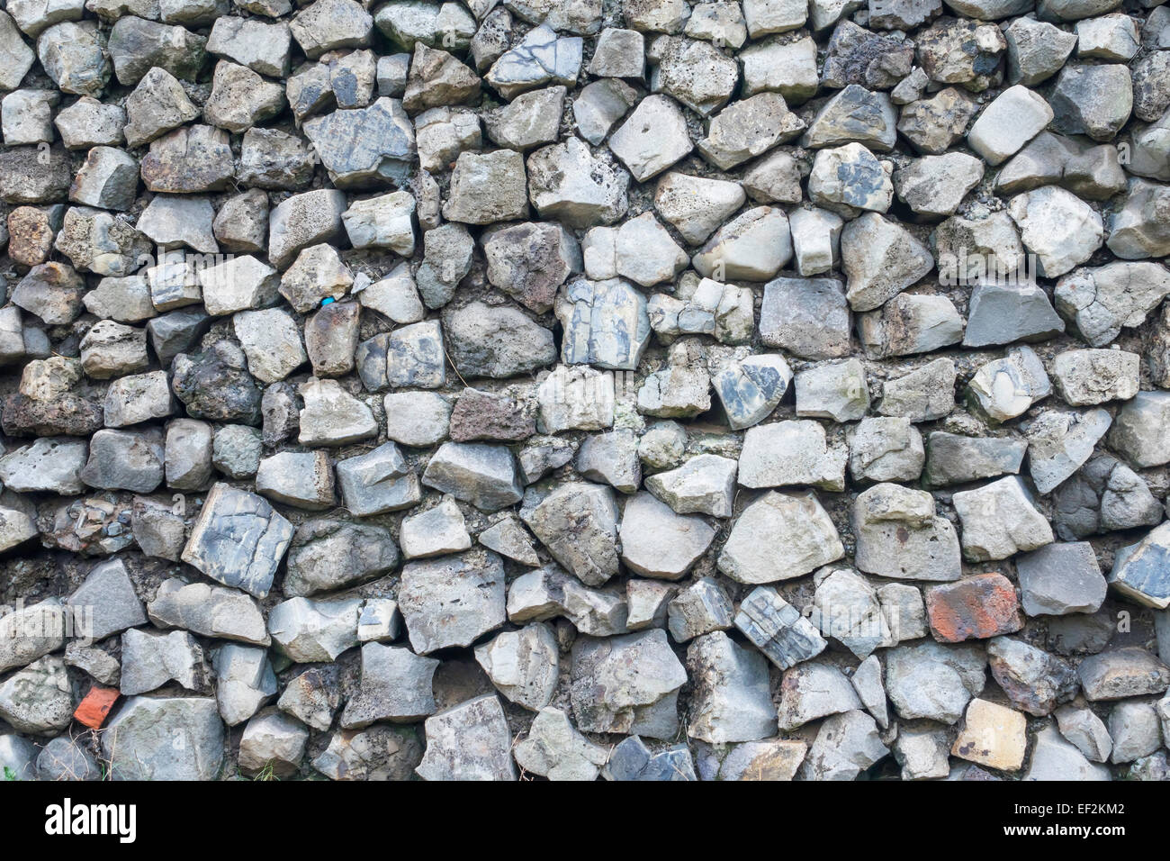Historic jetty wall constructed from slag blocks made from iron works ...