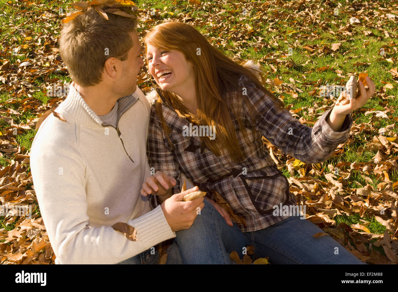 Couple being affectionate in a park Stock Photo - Alamy