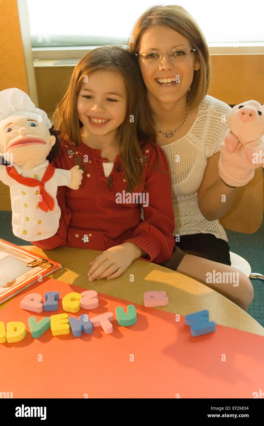 Woman and young girl playing with puppets Stock Photo - Alamy