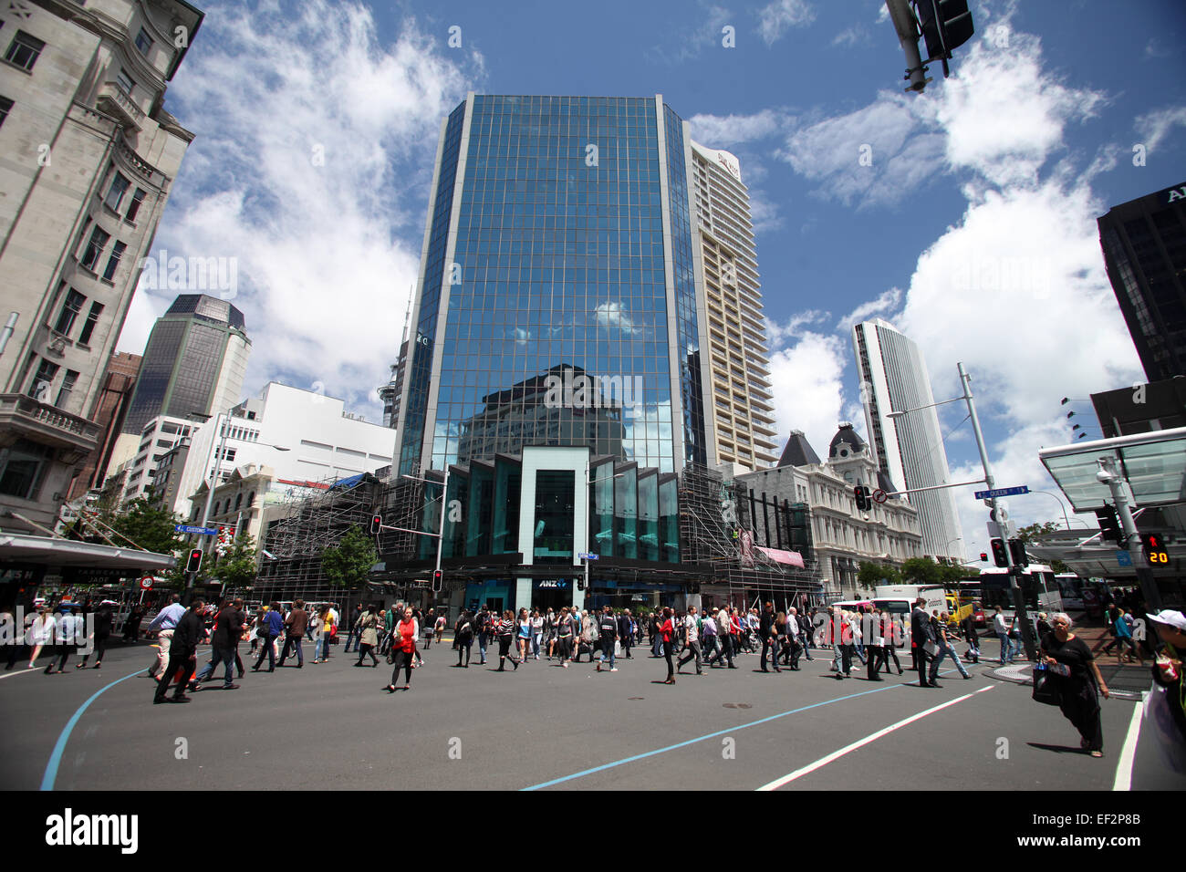 Pedestrians cross at the junction of Queen Street and Customs Street ...