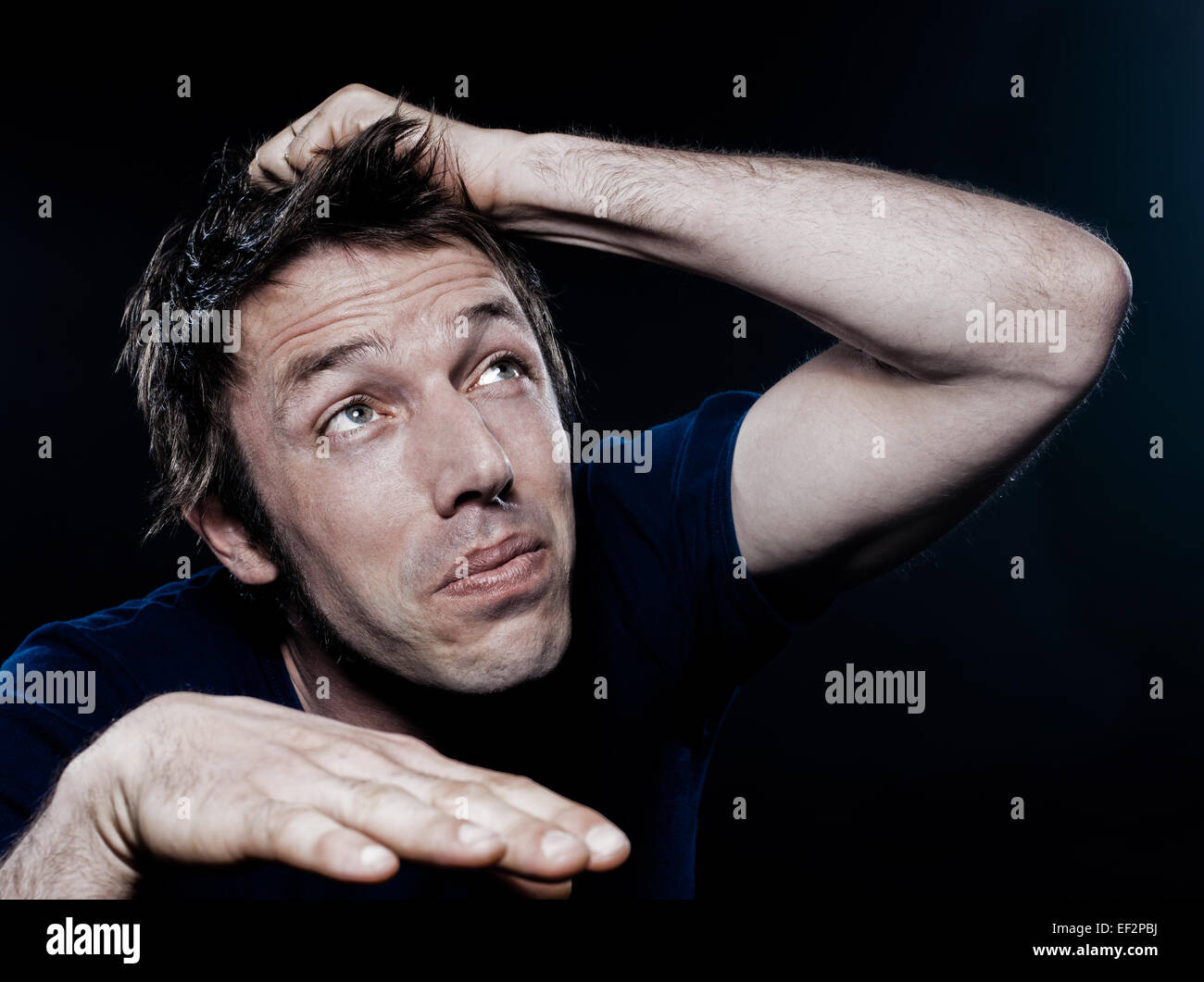 studio portrait on black background of a funny expressive caucasian man ...