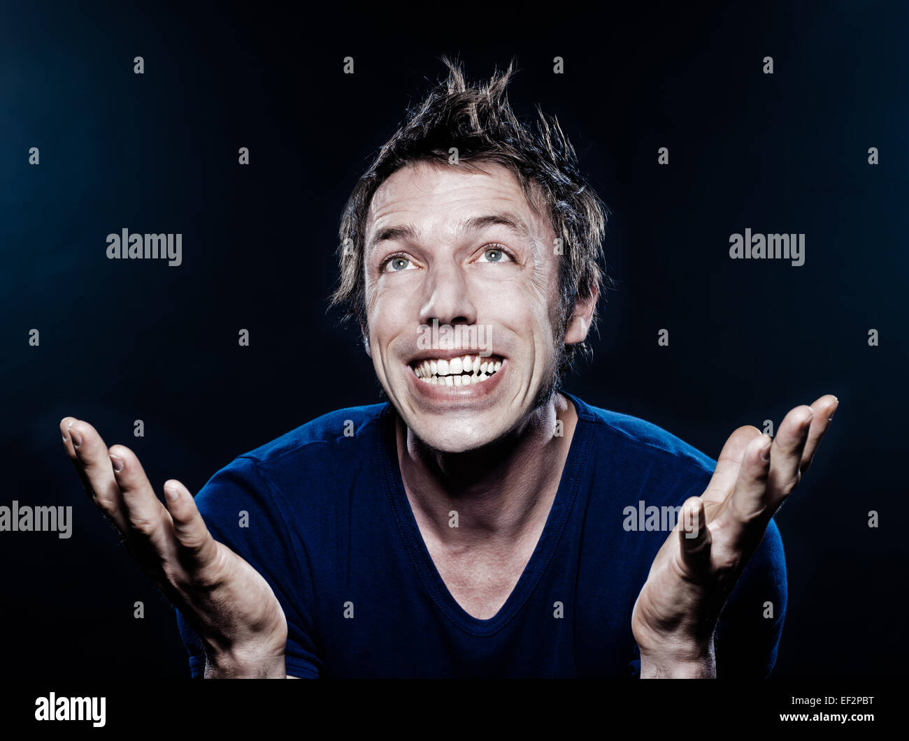 studio portrait on black background of a funny expressive caucasian man ...
