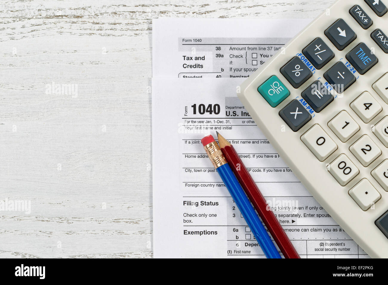 Top view of U.S. Individual tax form 1040 with old calculator and ...