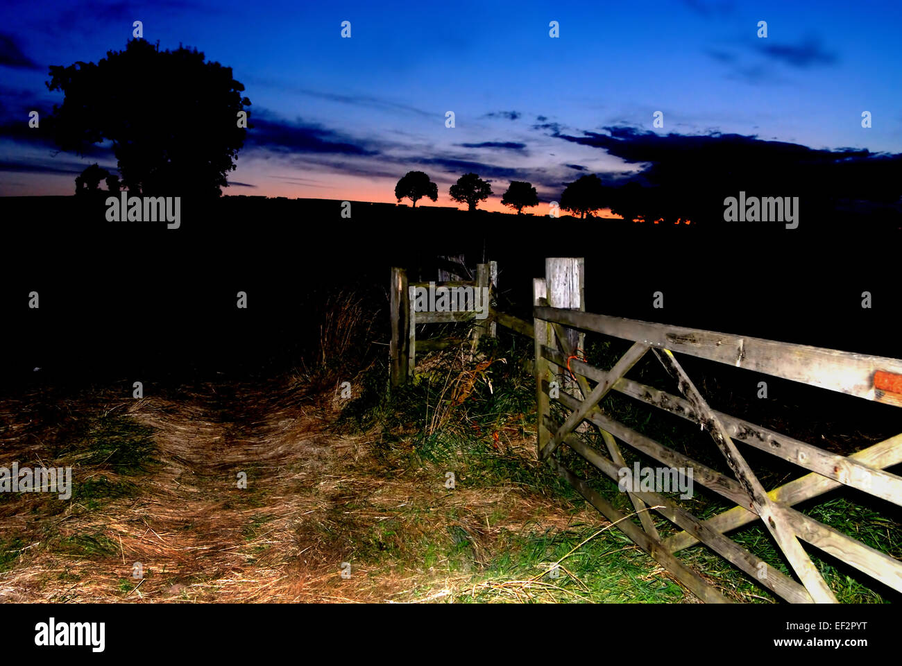 Sunset over farm gate Stock Photo - Alamy