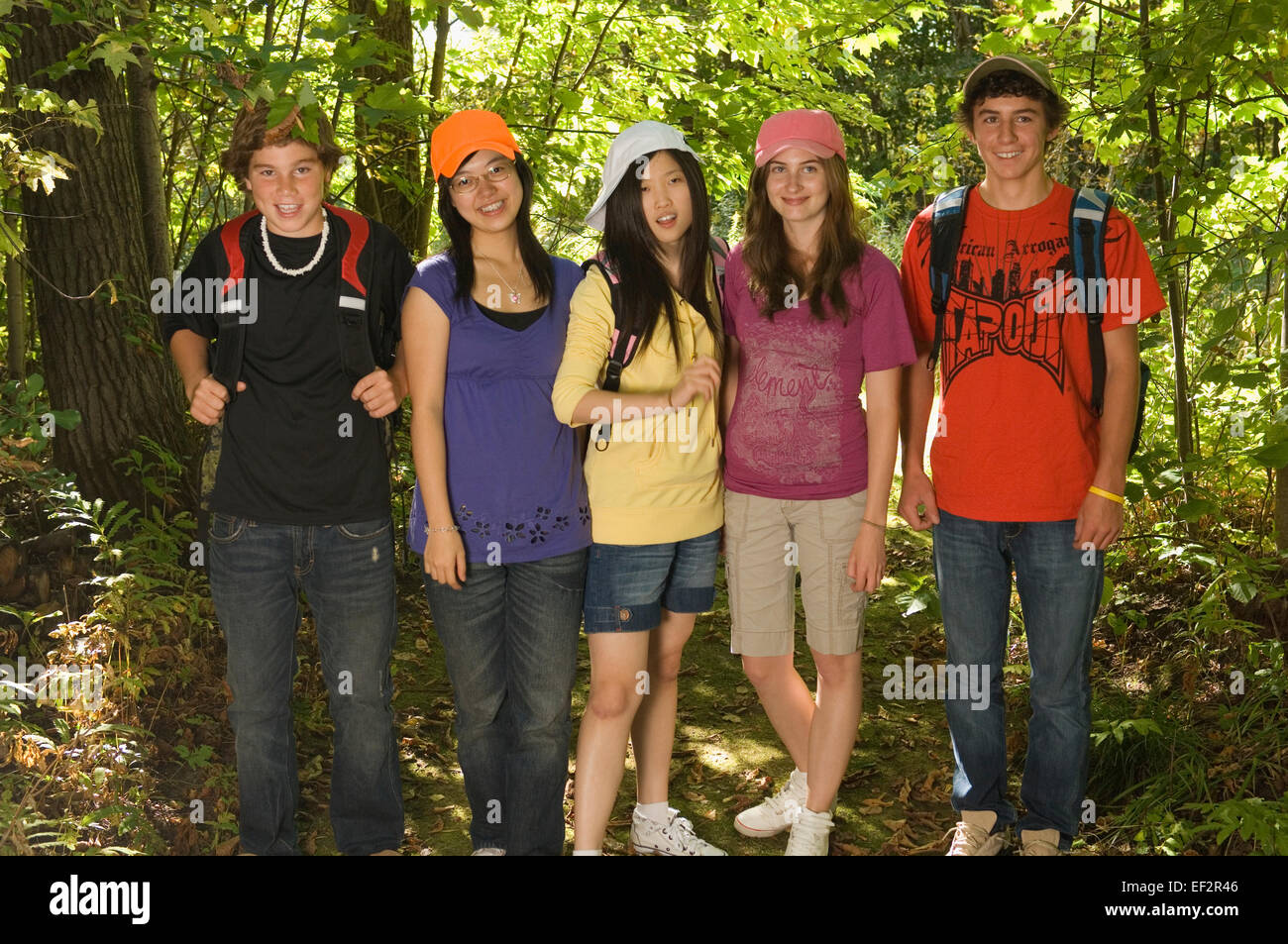 Group of friends in the forest Stock Photo - Alamy