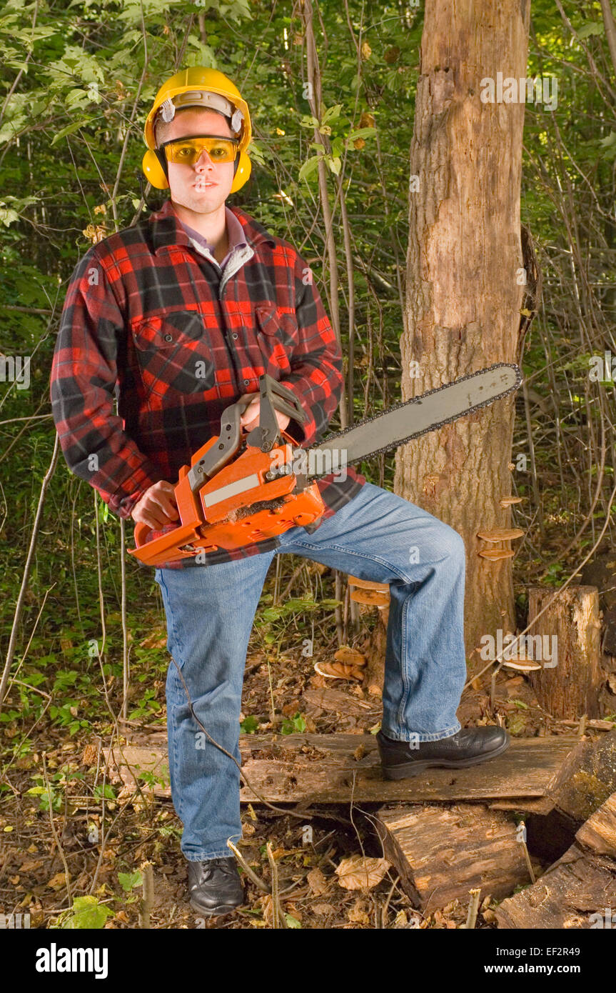 Man holding a chainsaw Stock Photo - Alamy