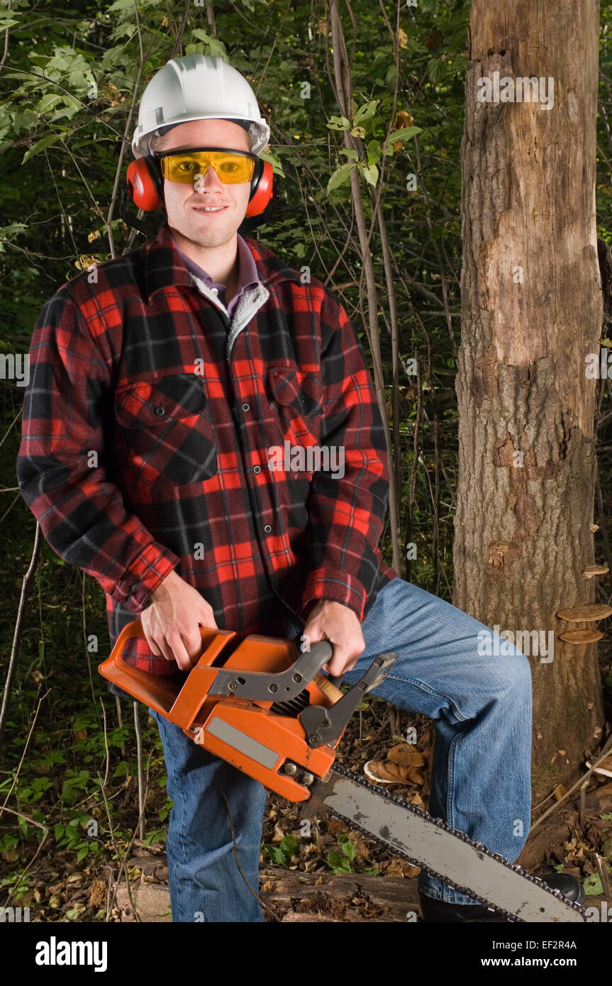 Man holding a chainsaw Stock Photo - Alamy
