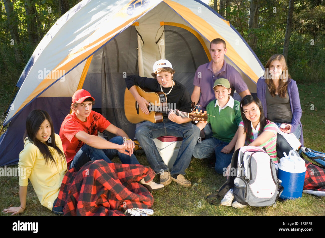 Group of friends in front of tent Stock Photo - Alamy