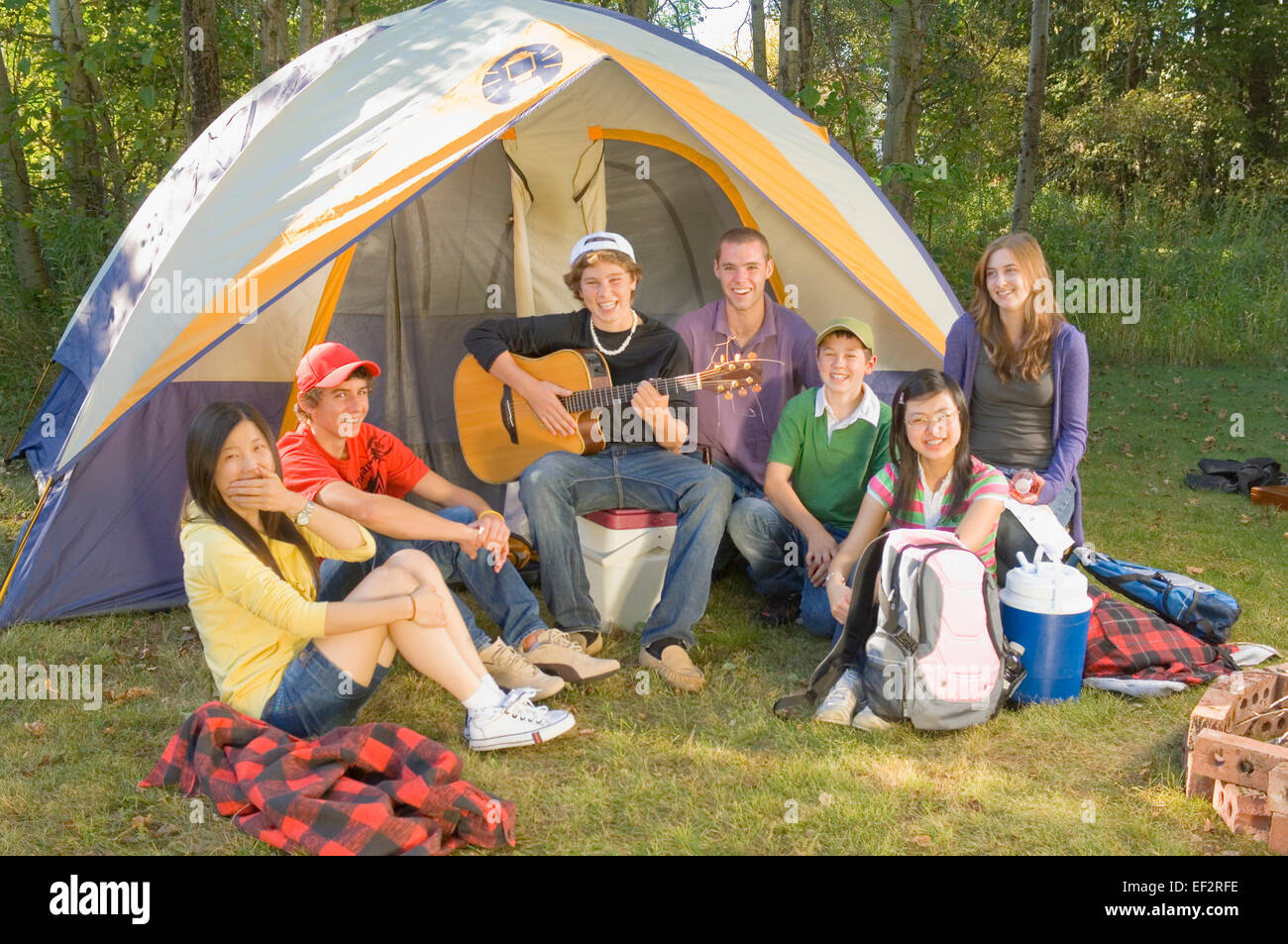 Group of friends in front of tent Stock Photo - Alamy