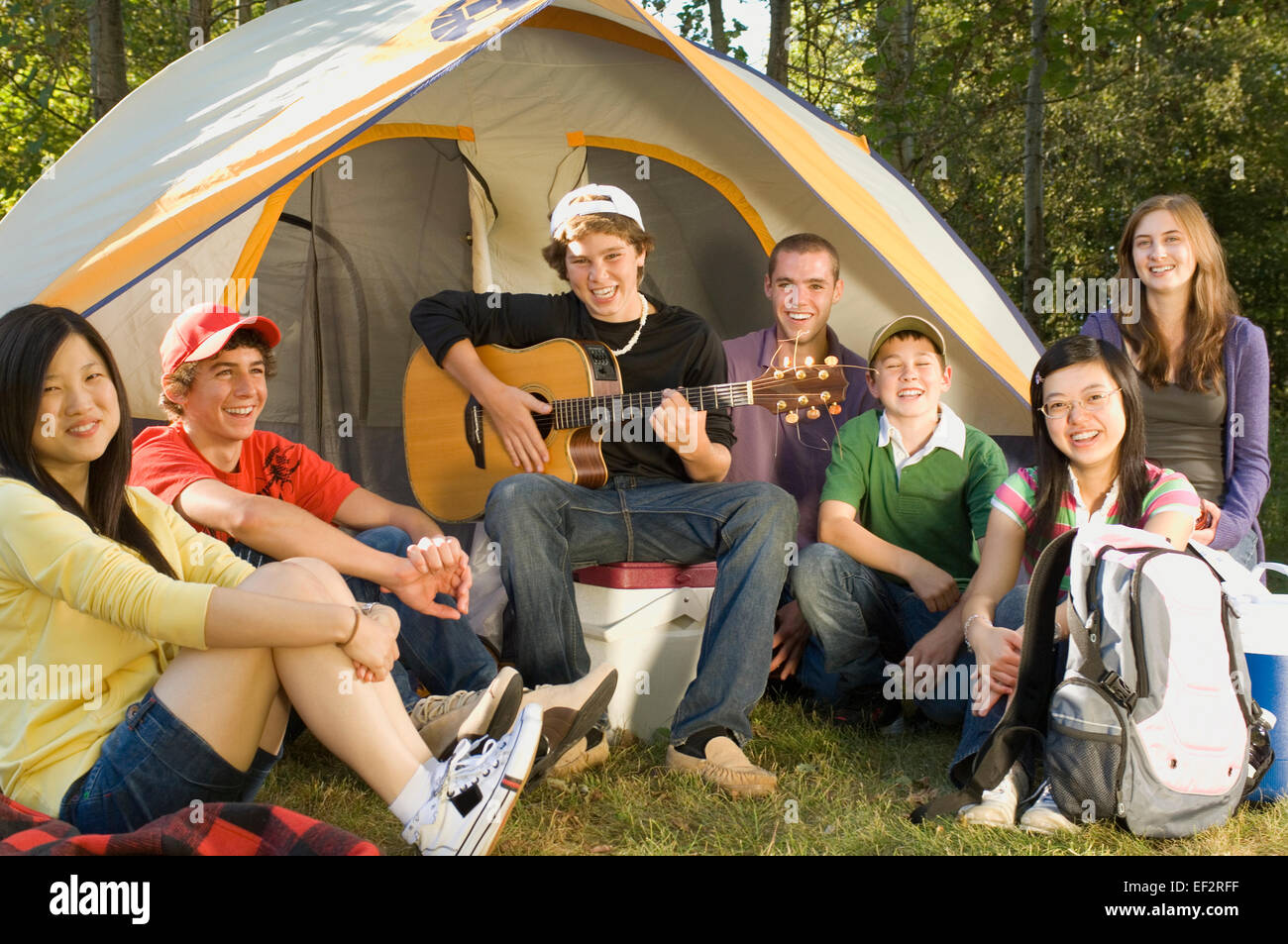 Group of friends in front of tent Stock Photo - Alamy