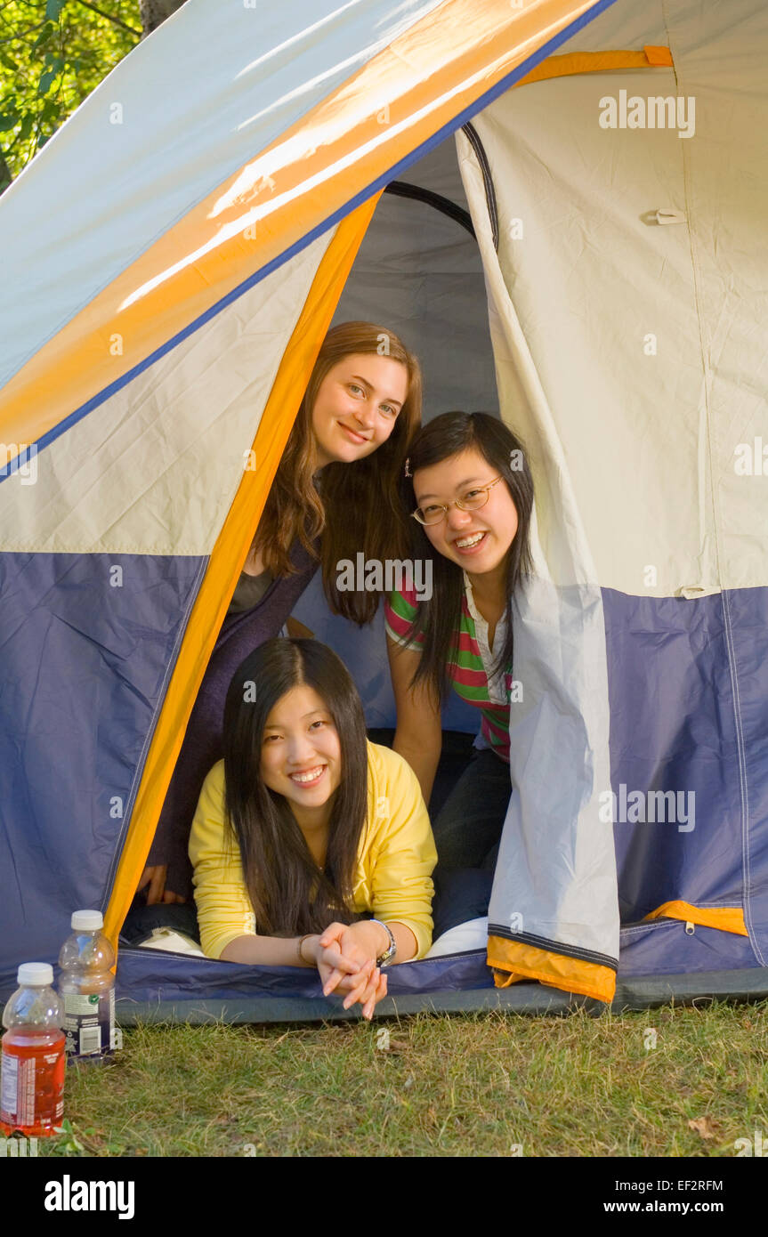 Three girls in a tent Stock Photo - Alamy