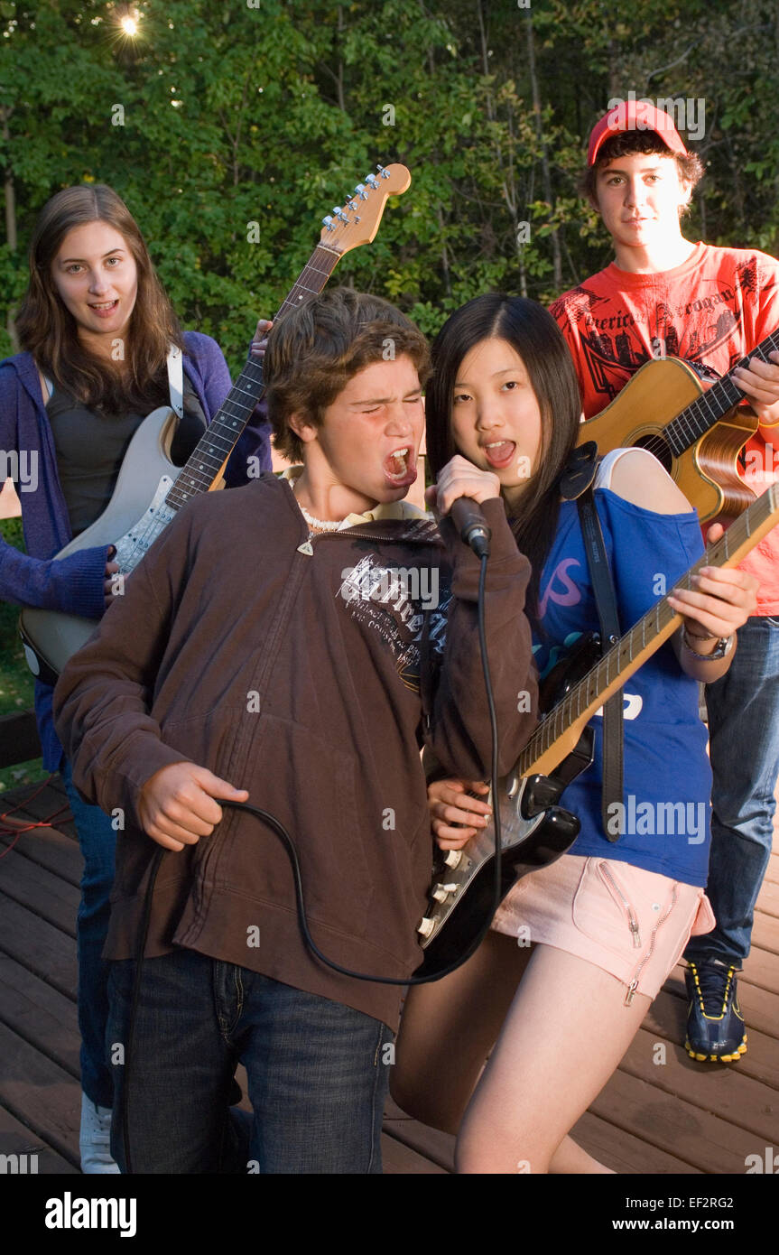 Teenage band playing on an outdoor deck Stock Photo - Alamy