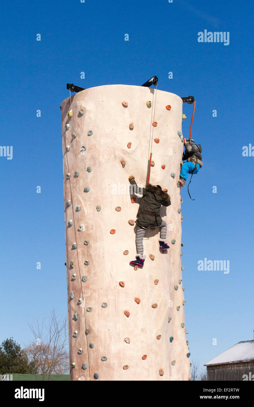 Two people scale the climbing wall at the Winter Festival in Cannington ...