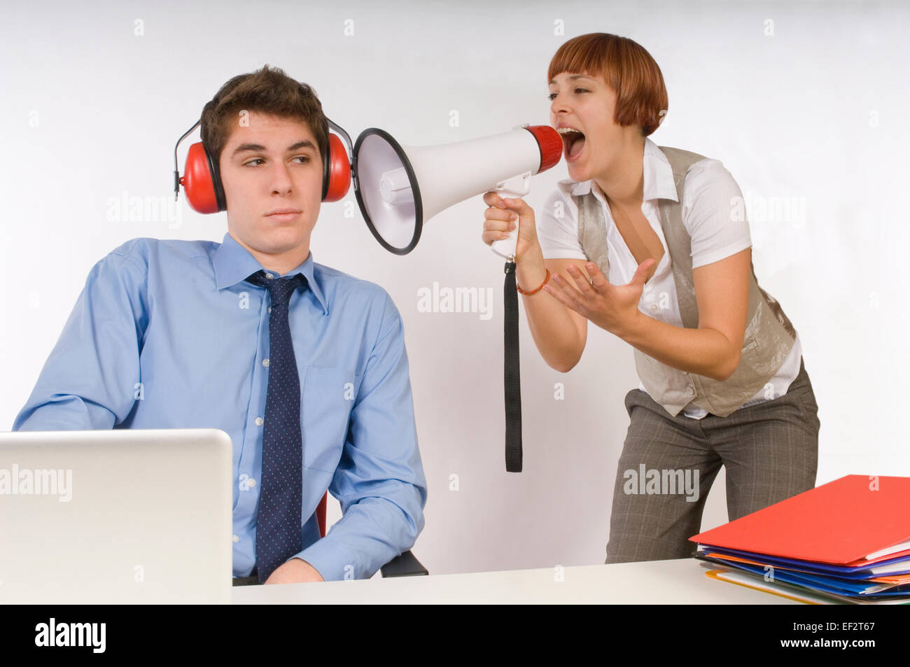 Woman using a bullhorn to yell at daydreaming businessman Stock Photo ...