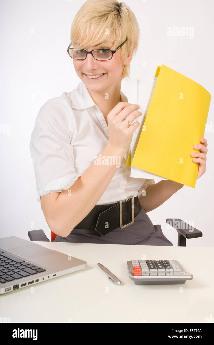 Blond woman working at her desk Stock Photo - Alamy