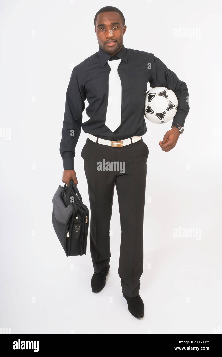 Businessman carrying a soccer ball Stock Photo - Alamy
