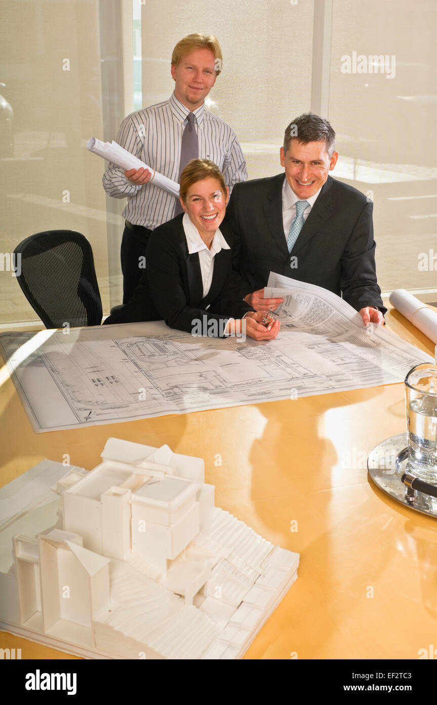 Architects looking at blueprints Stock Photo - Alamy