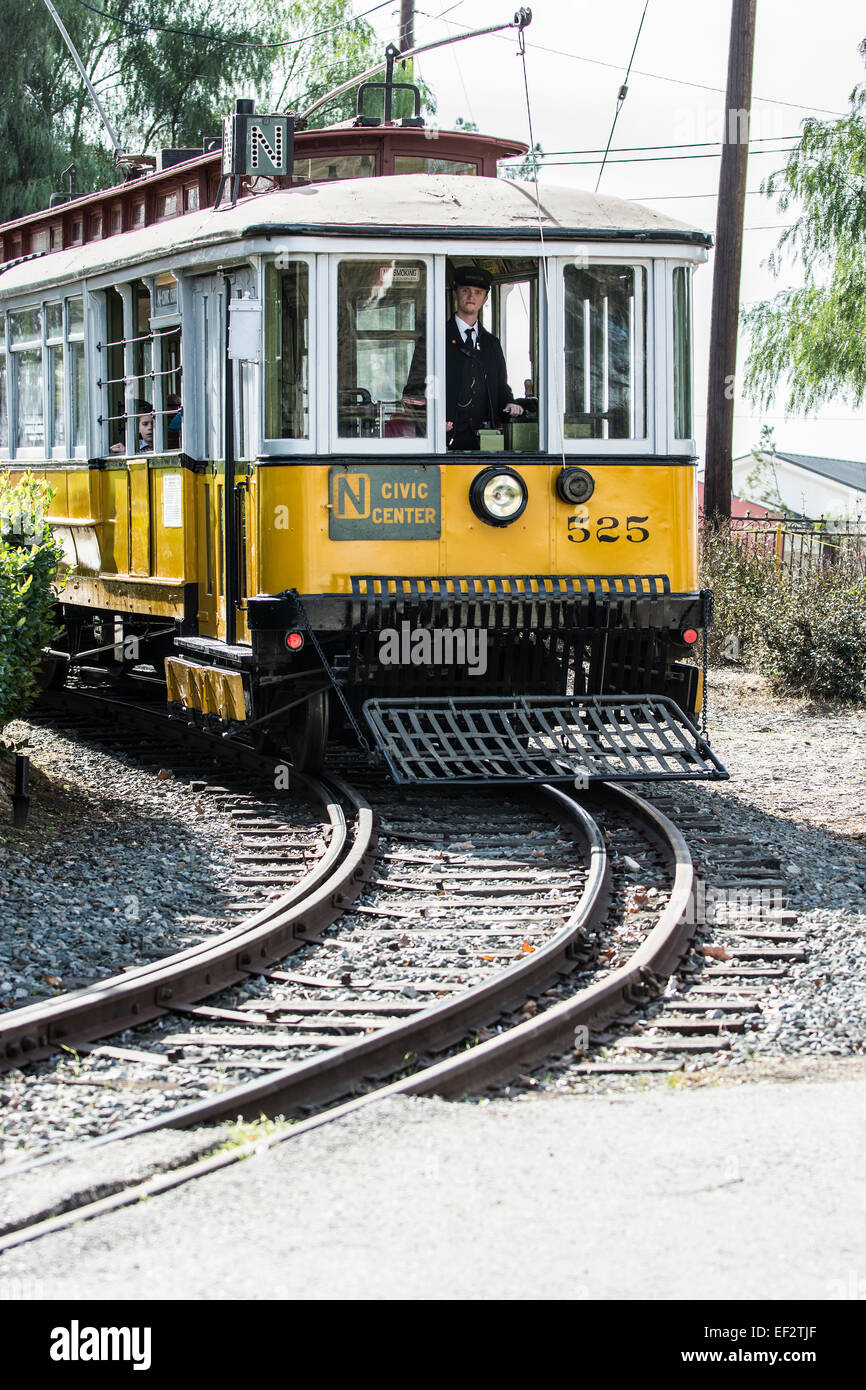 An electric trolley car moving down train tracks Stock Photo - Alamy