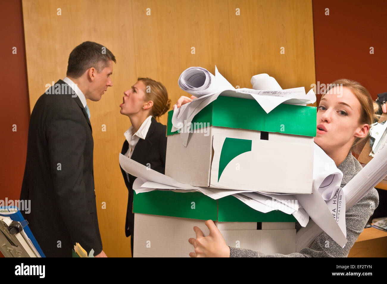 Office receptionist carrying boxes and blueprints Stock Photo - Alamy