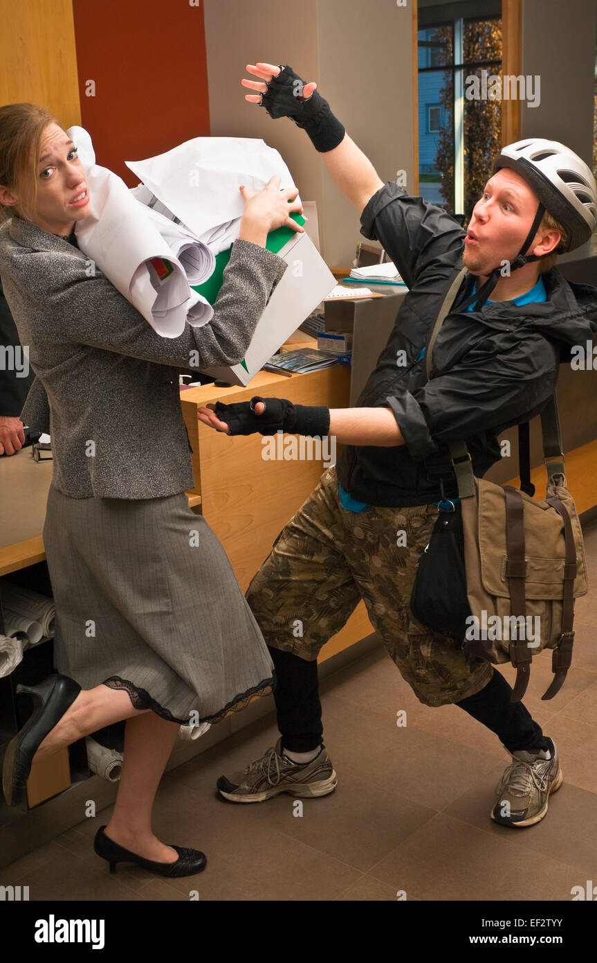Bike courier trying to help overworked office receptionist Stock Photo ...