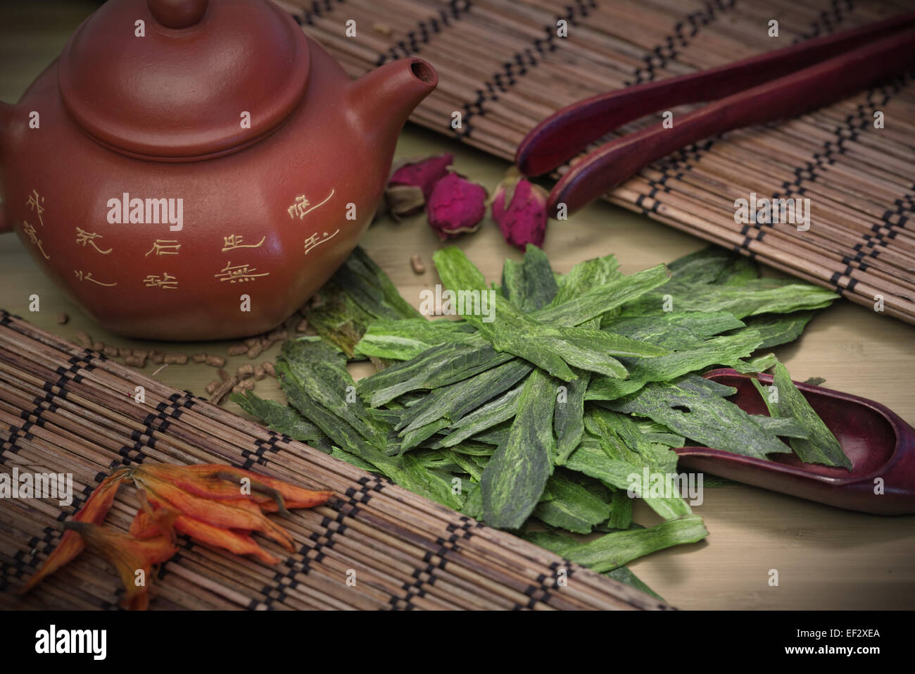 Tai Ping Hou Kui tea. Green tea leaves with clay teapot and wooden ...