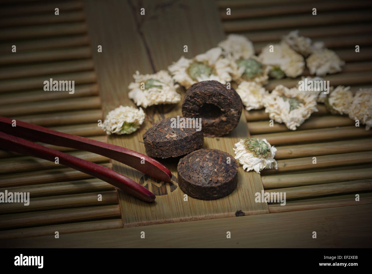 Hua Xiao Tuo. Black compressed tea with Chrysanthemum tea on a tea tray ...