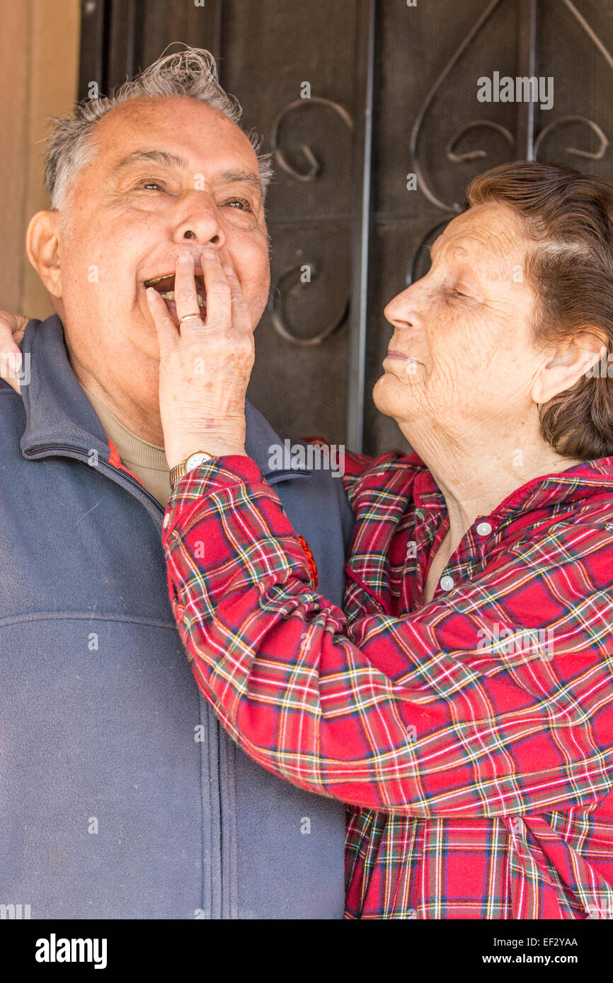 A retired, Latin American couple share a fun moment together Stock ...