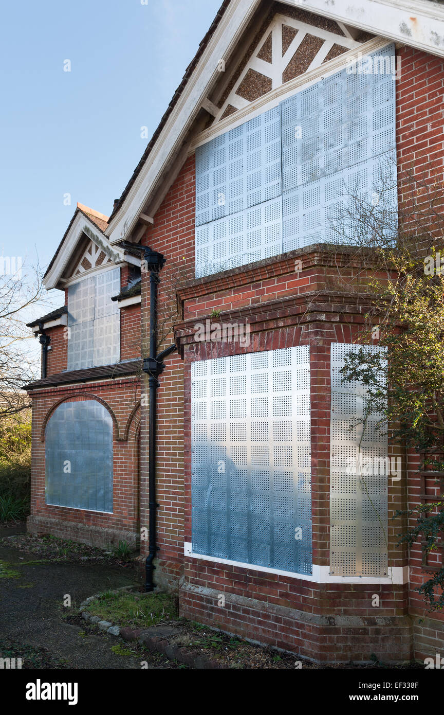 detached house in overgrown garden with metal security sheets boarded ...