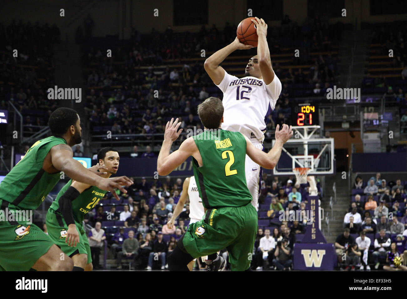 Andrew Andrews (12) elevates to shoot a jumper over Oregon defenders ...
