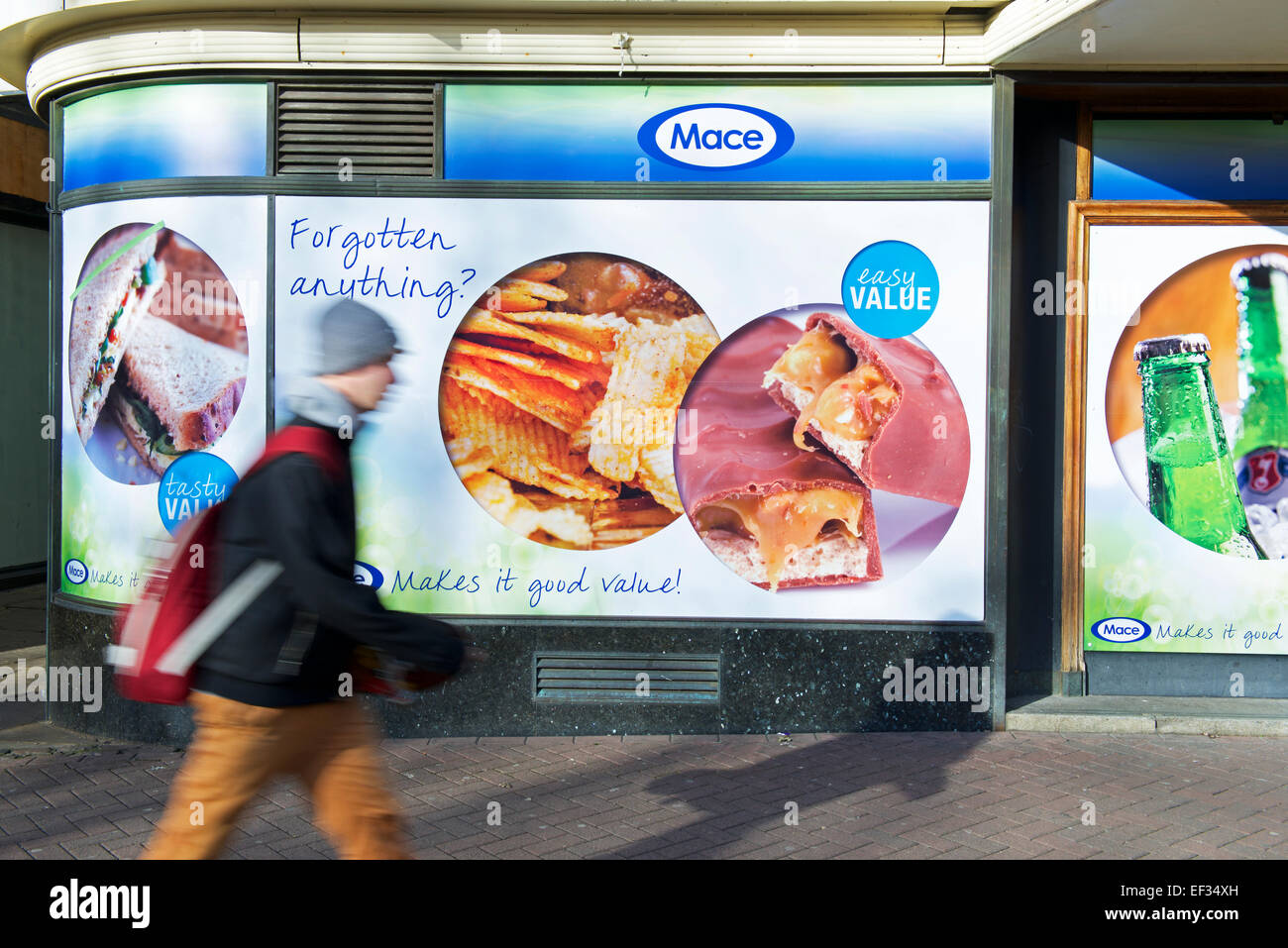 Man walking past Mace convenience store, England UK Stock Photo - Alamy