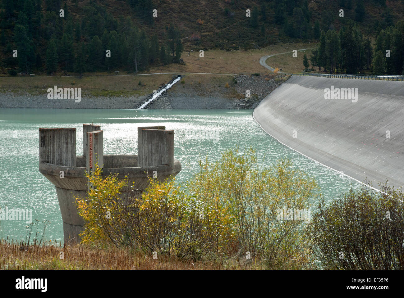 Overflow funnel and dam at Längentalspeicher reservoir, Tyrol, Austria ...
