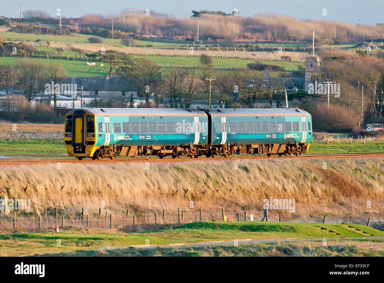 Arriva train passing through Rhosneigr Anglesey North Wales Uk Stock ...