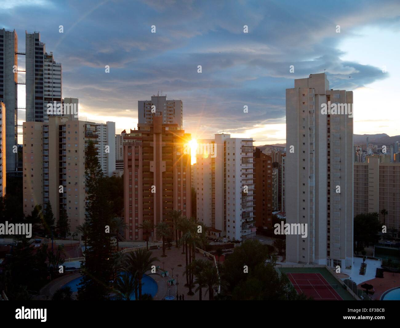 Benidorm sun going down behind apartment buildings Stock Photo - Alamy