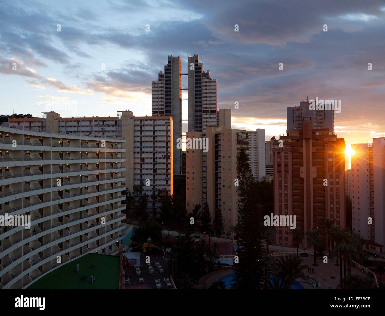 Benidorm sun going down behind apartment buildings Stock Photo - Alamy