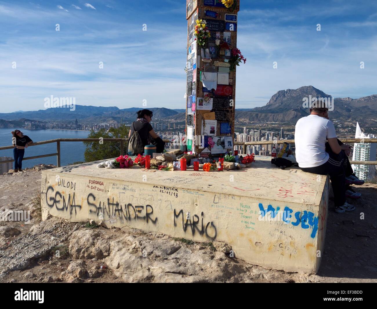 People sitting on the base of The Benidorm Cross Stock Photo - Alamy