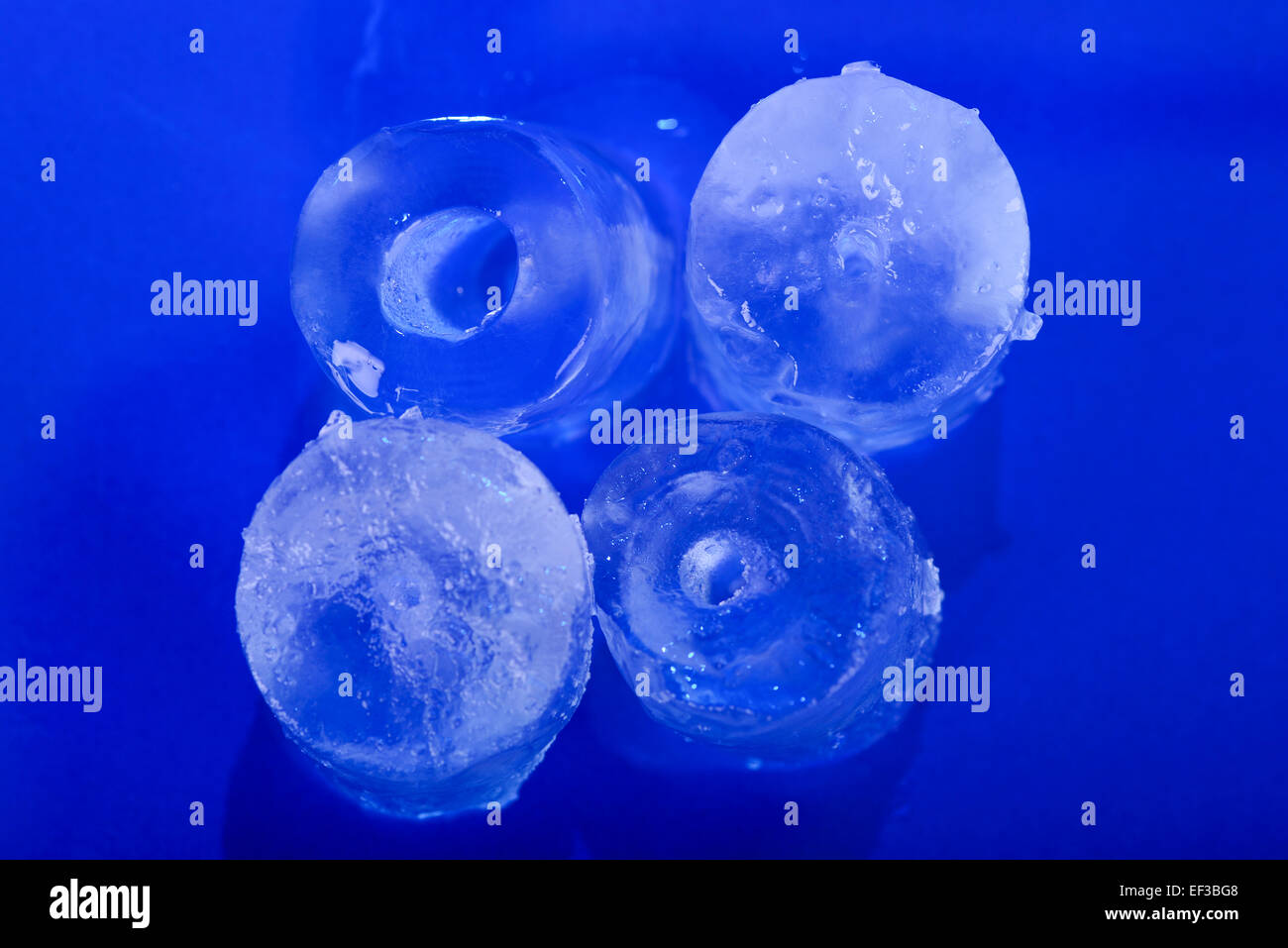 wet ice cubes on blue background Stock Photo - Alamy