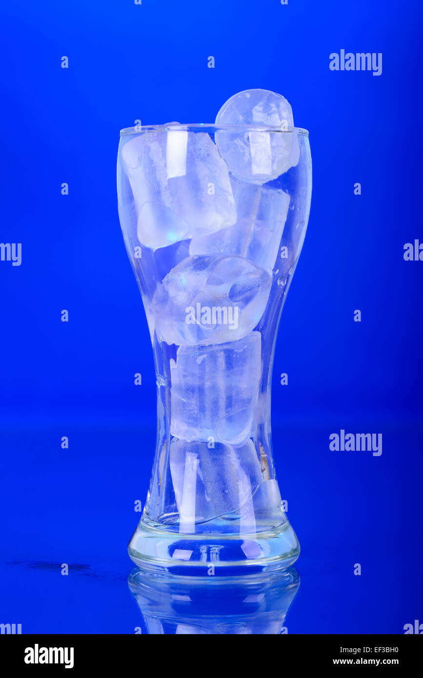 wet ice cubes on blue background Stock Photo - Alamy
