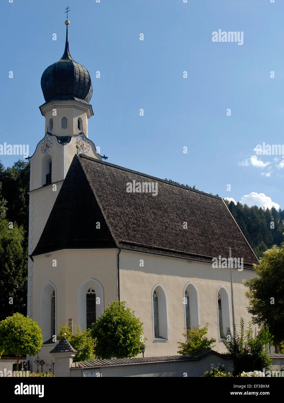 This photograph captures the picturesque Pfarrkirche Pill, a historic ...