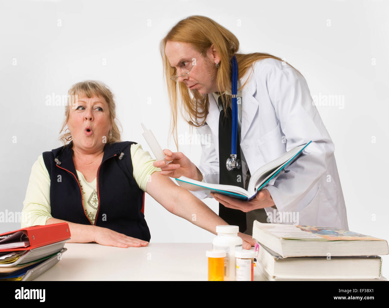 Nervous patient and crazy looking doctor Stock Photo - Alamy