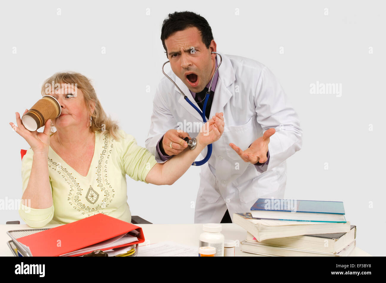 Female doctor listens man stethoscope hi-res stock photography and ...