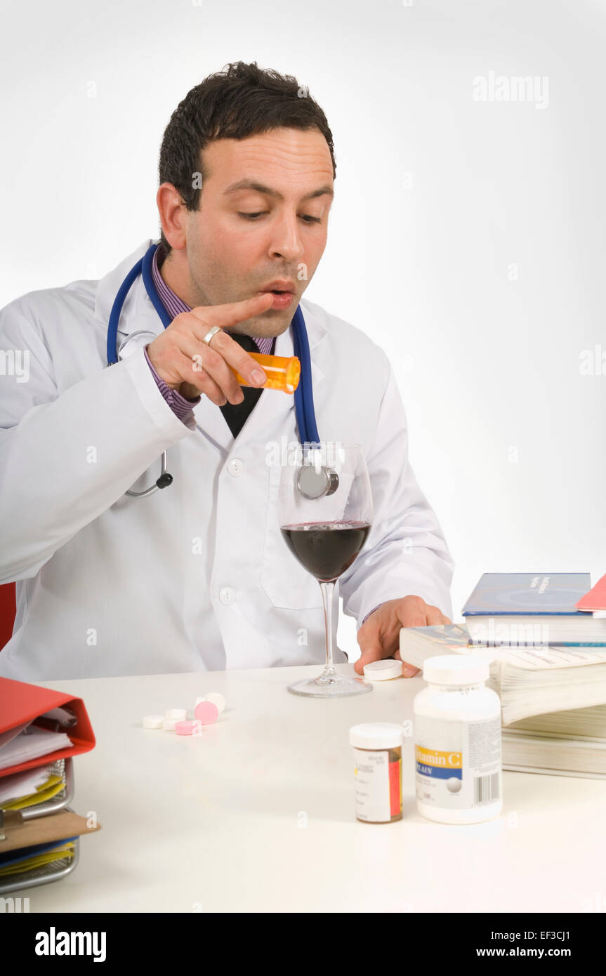 Doctor putting pills in glass of wine Stock Photo - Alamy