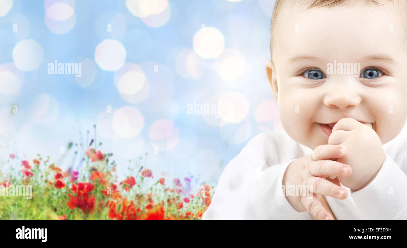 beautiful happy baby over poppy field background Stock Photo - Alamy