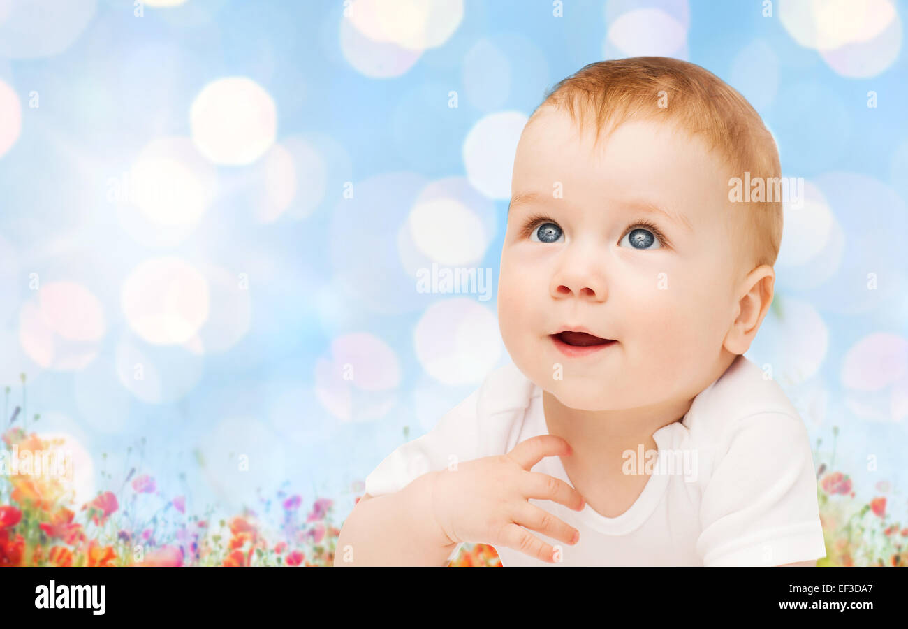 beautiful happy baby over poppy field background Stock Photo - Alamy