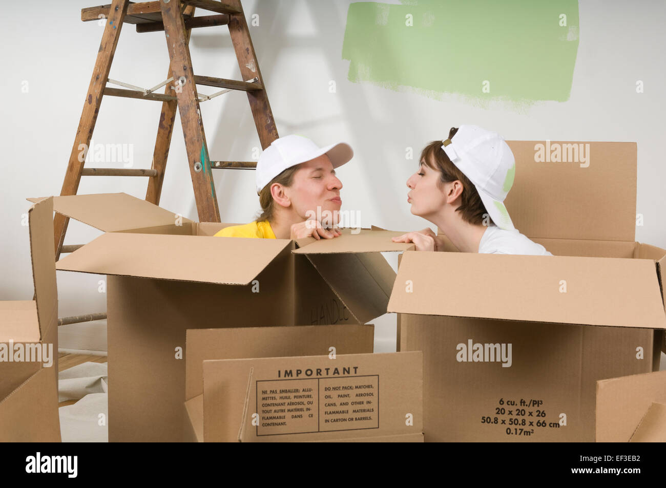 Playful couple inside cardboard boxes Stock Photo - Alamy