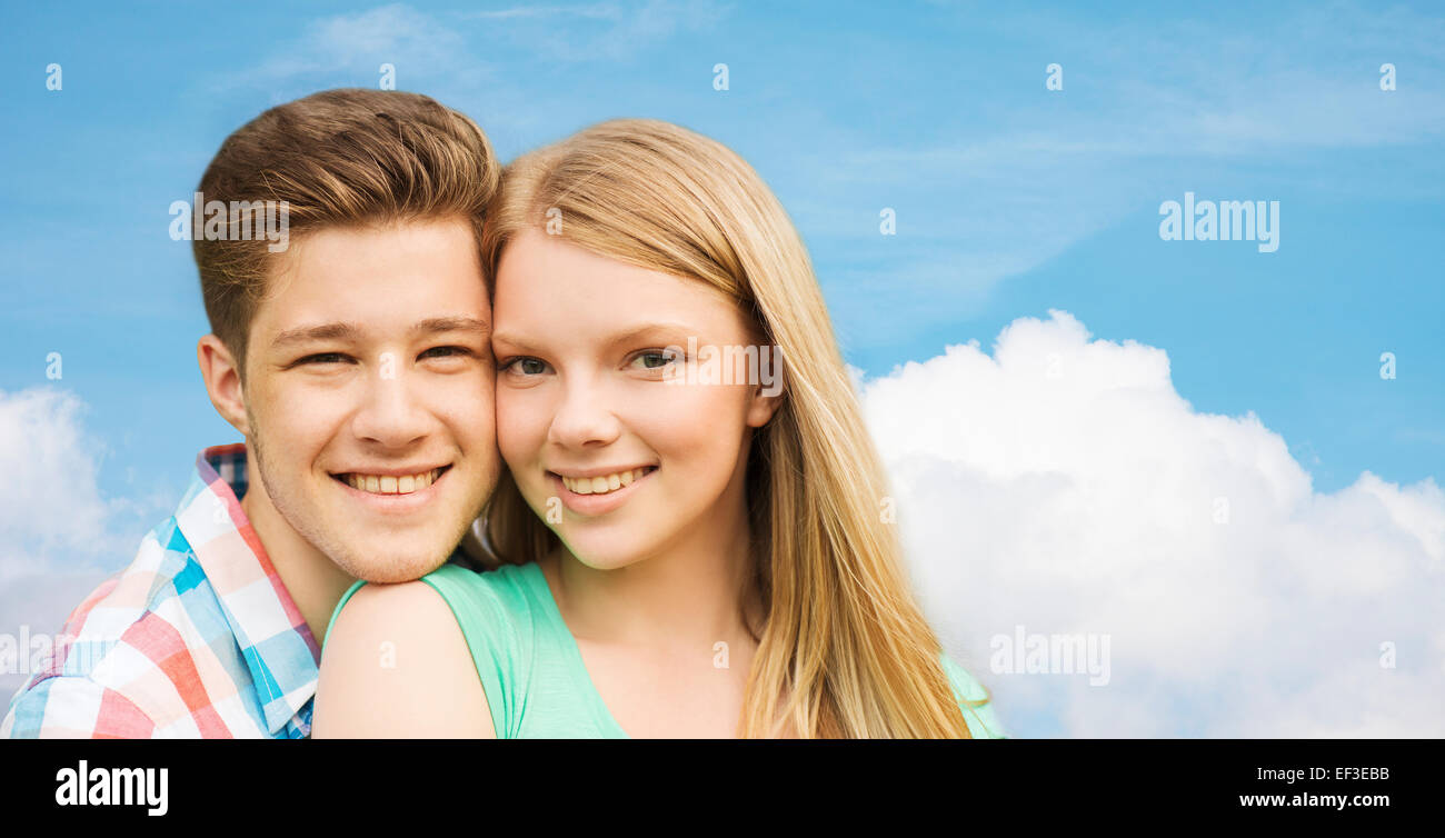 smiling couple hugging over blue sky background Stock Photo - Alamy