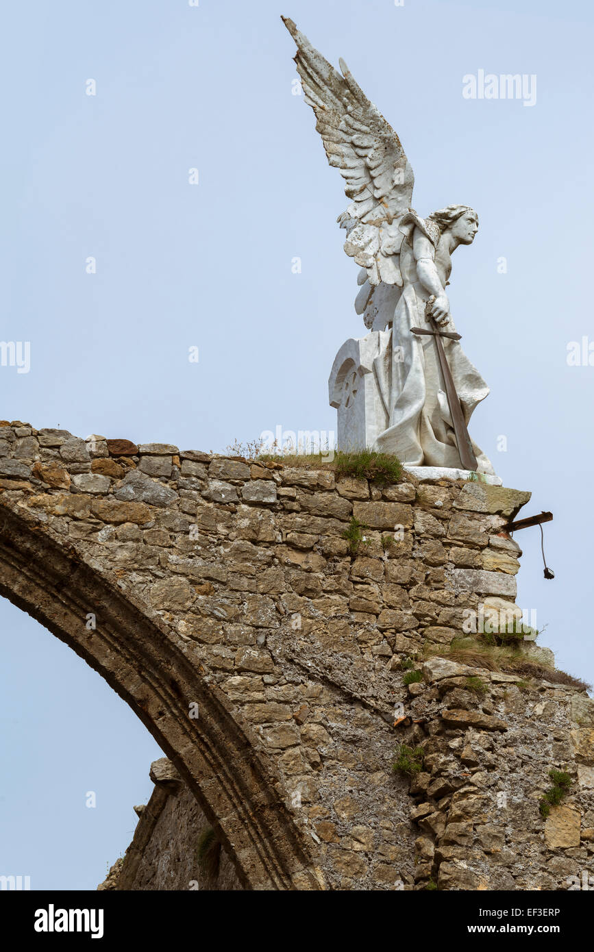 Sculpture of a guardian angel on a stone arch, with a sword in the ...