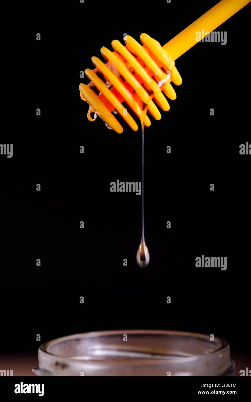 Drops of honey on a light background Stock Photo - Alamy
