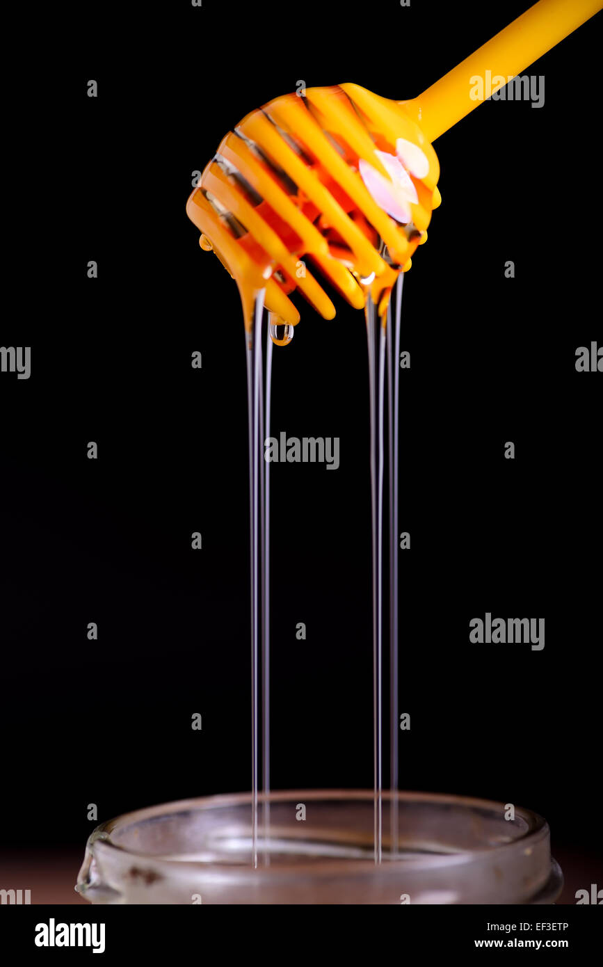 Drops of honey on a light background Stock Photo - Alamy