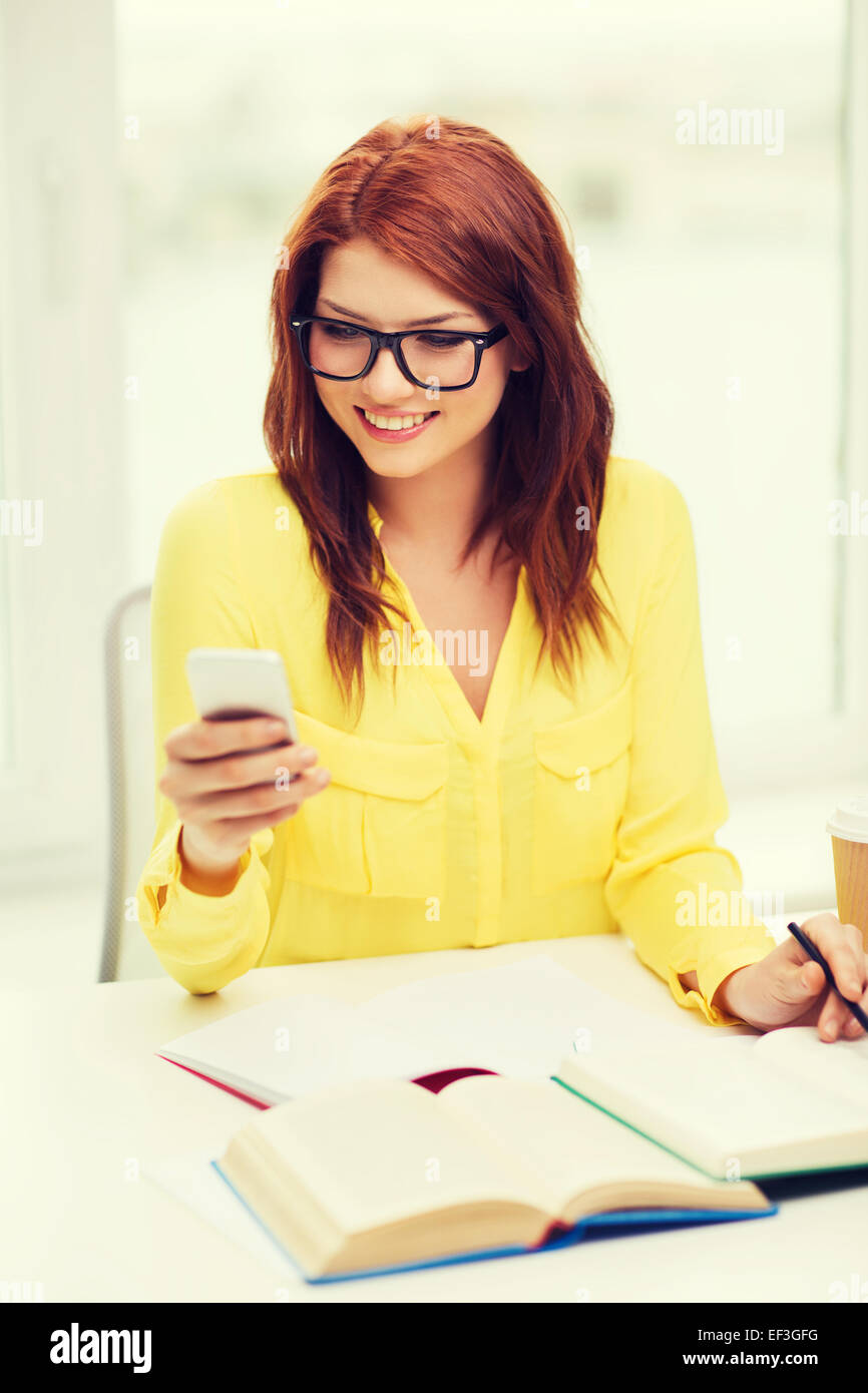 smiling student girl with smartphone at school Stock Photo - Alamy